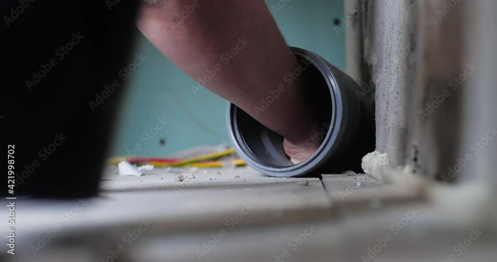 Installation of back pitched sewer pipe in the house. Conducting ...