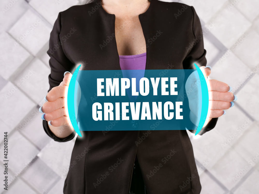 EMPLOYEE GRIEVANCE text in futuristic screen. Stock Photo | Adobe Stock