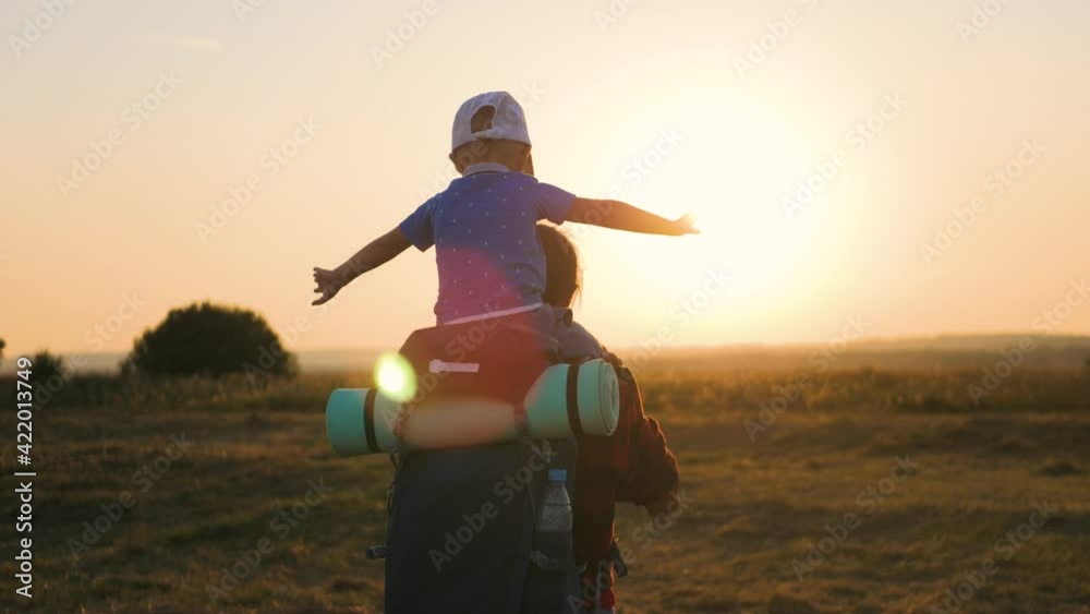 Happy family, mother and little son silhouettes playing on meadow. Boy ...
