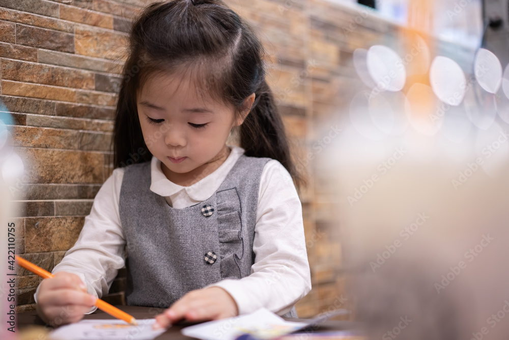 Back to school. Happy smiling pupil drawing at the desk. Cute little ...