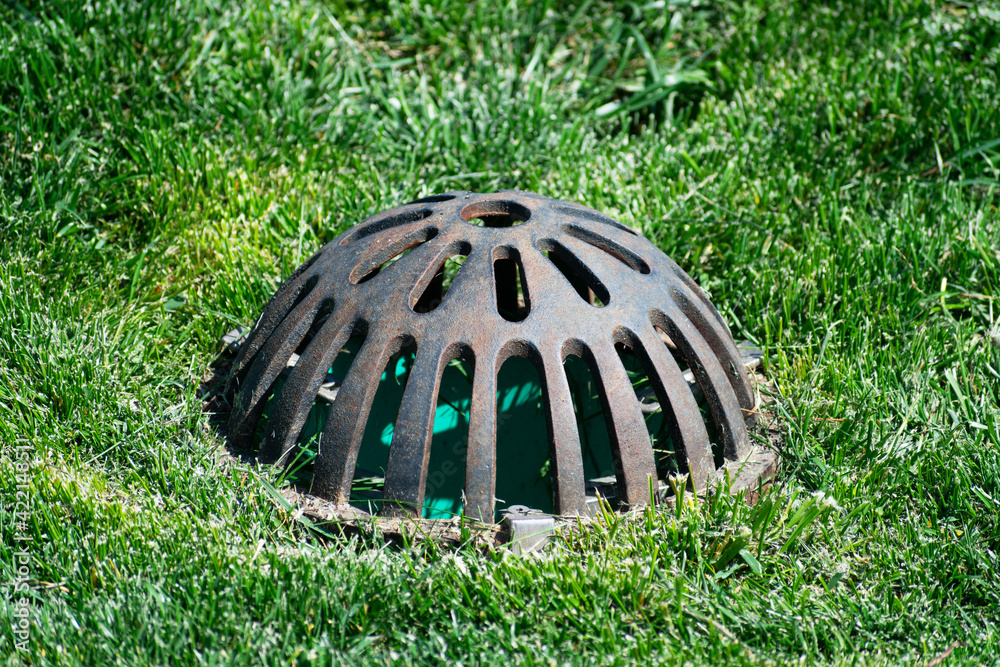 Catch basin atrium drainage grate over storm water drain surrounded by ...