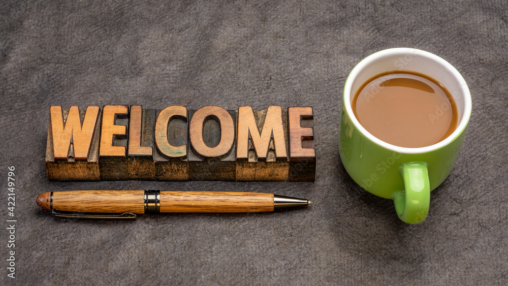 welcome sign - word in vintage letterpress wood type with a cup of ...