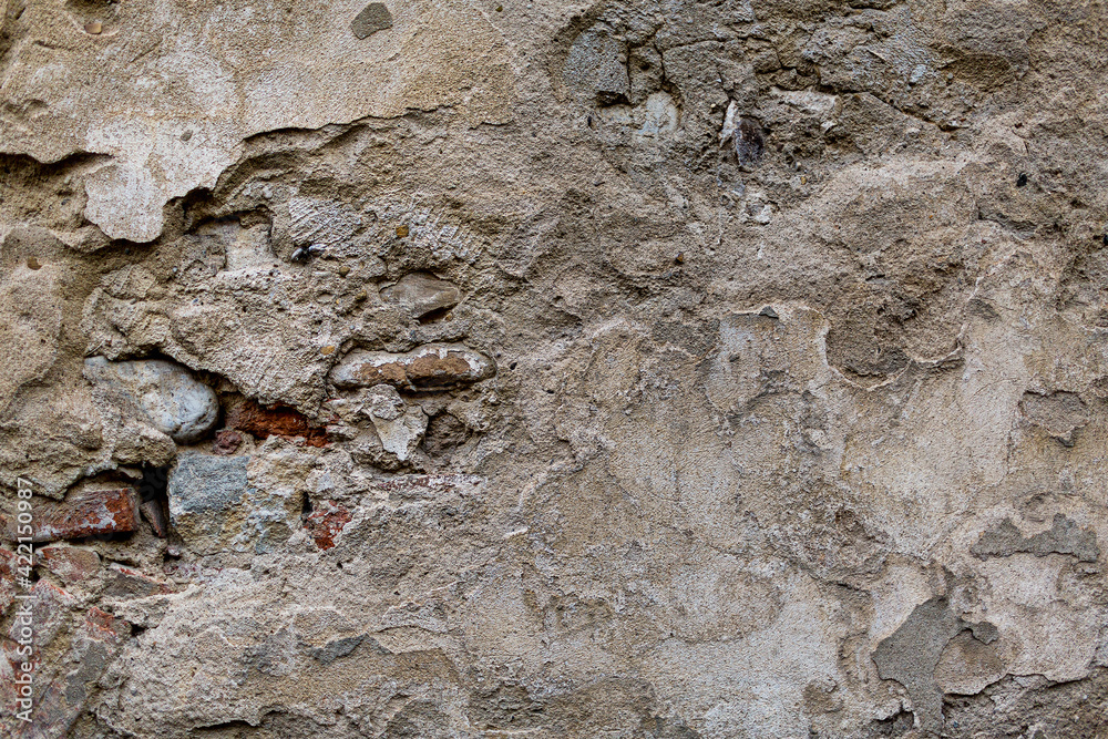 Old dark gloomy dirty crumbling brick wall of ancient facade. Uneven ...
