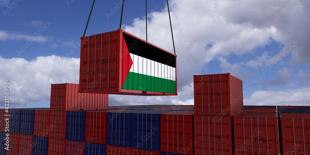 A freight container with the palestinian flag hangs in front of many ...
