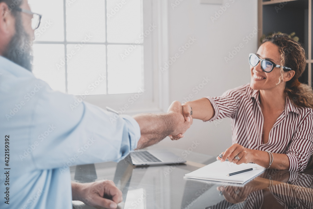 Smiling caucasian female hr manager handshake hire male candidate at ...