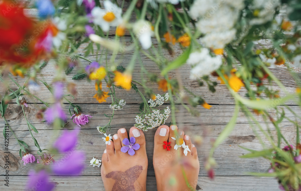 Summer lifestyle portrait of a attractive girl's feet with buds of ...
