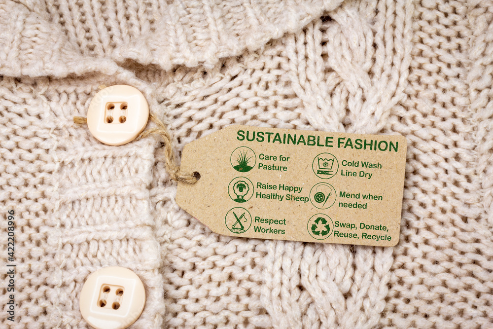 sustainable fashion label on woollen jumper with care icons and text ...
