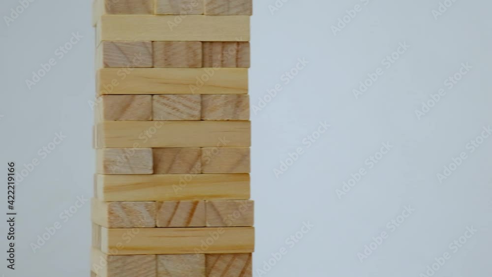 Wooden block removal tower game rotating at home. Having fun together ...