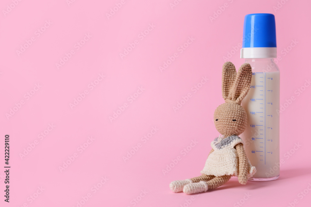 Bottle of milk for baby and toy on color background Stock Photo | Adobe ...