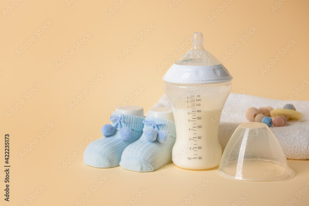 Bottle of milk for baby and accessories on color background Stock Photo ...