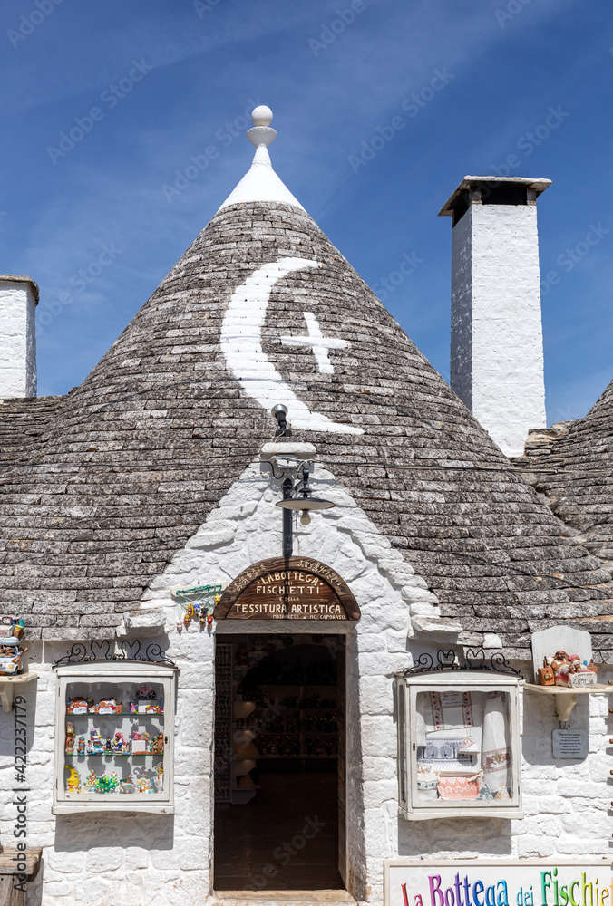 Souvenir shop in traditional white trulli house with conical roofs and ...