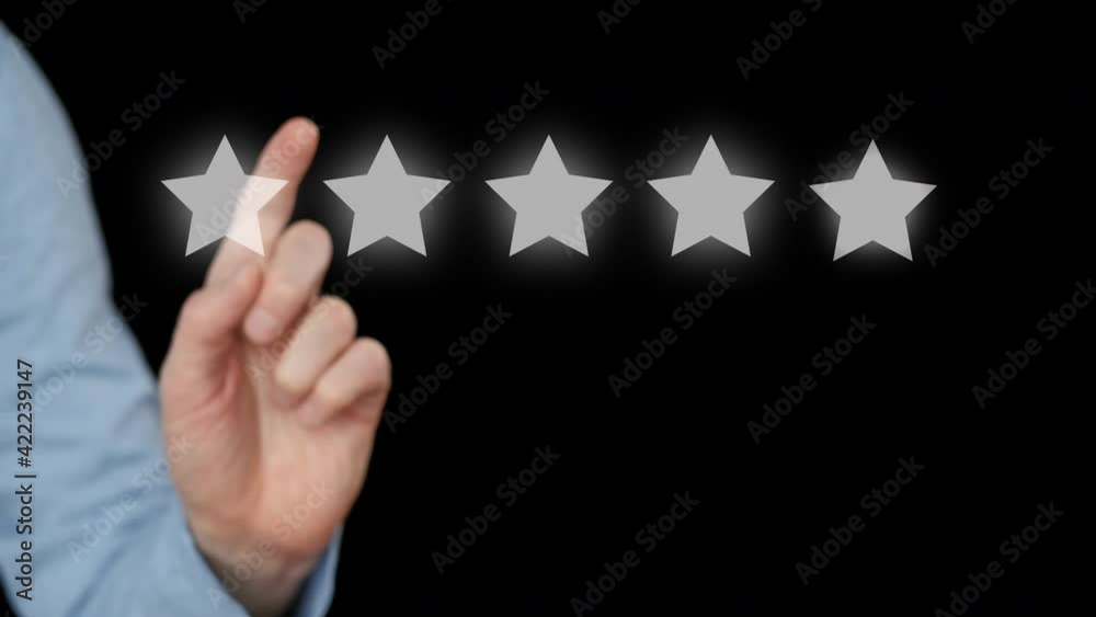 Male hand marking feedback from 5 silver and golden stars on ...