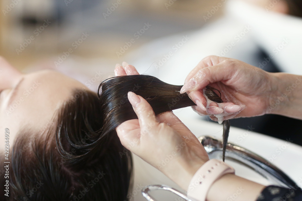 hairdresser hand washing hair on client closeup photo in hair salon ...