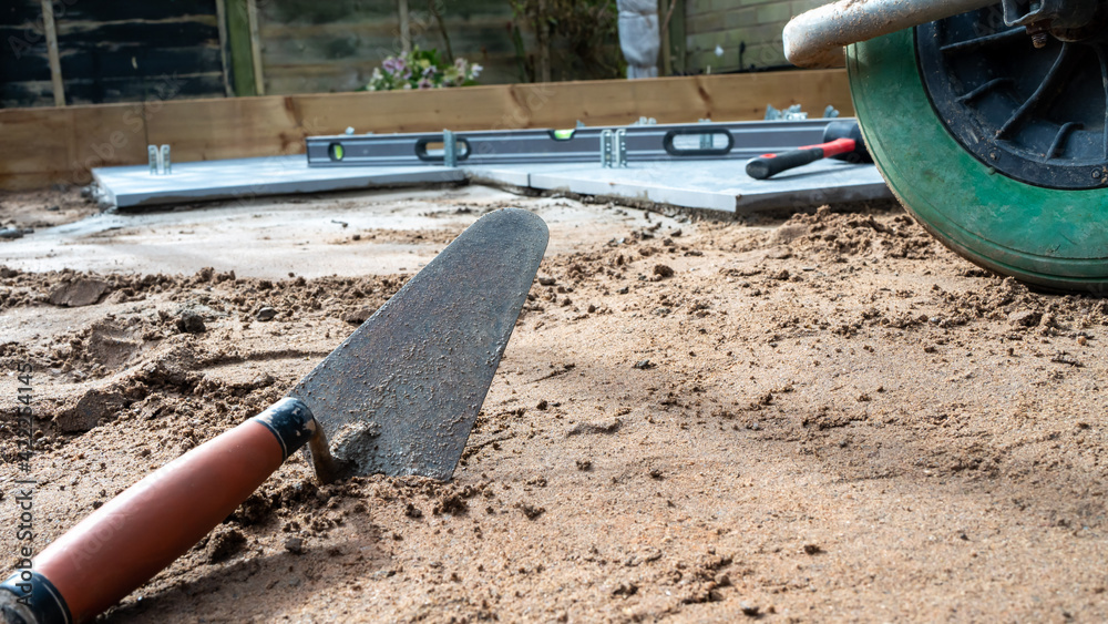 Trowel laying on the ground ready to lay a patio Stock Photo | Adobe Stock