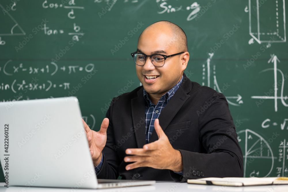 Indian young teacher man sitting teaching online video conference live ...