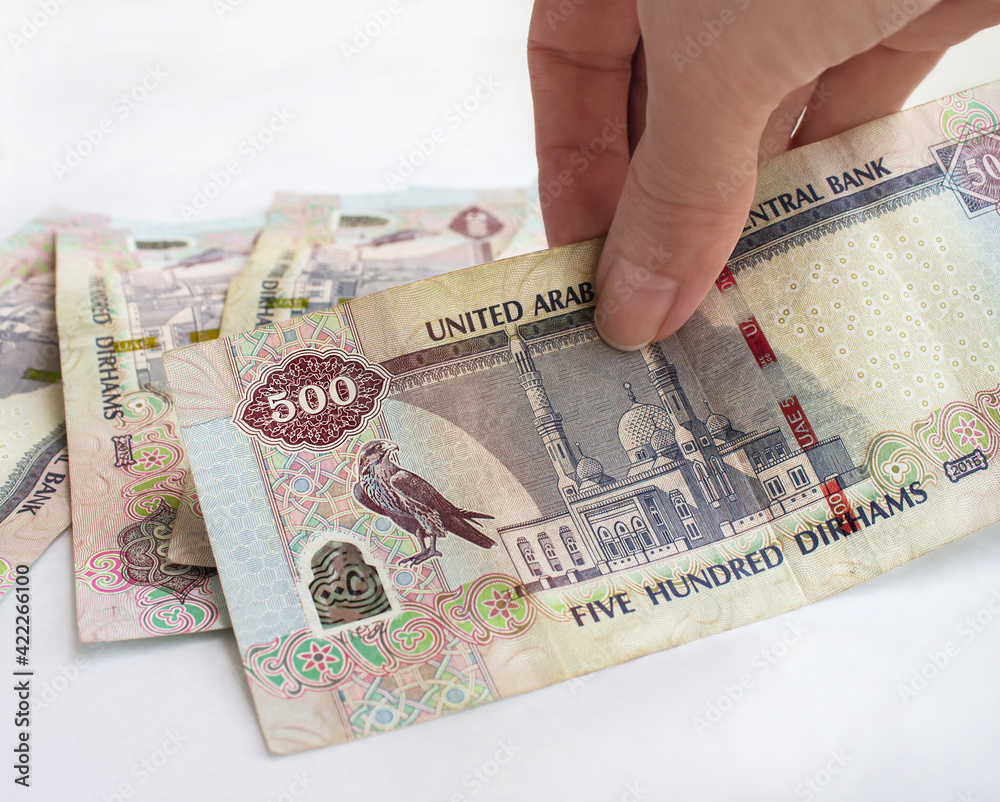 Hand holding 500 dirhams bill, United Arab Emirates (UAE) currency, on ...