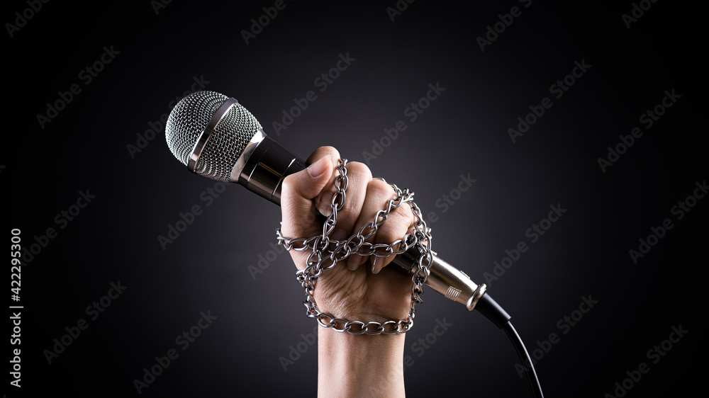 World press freedom day concept. Hand holding a microphone with chain ...