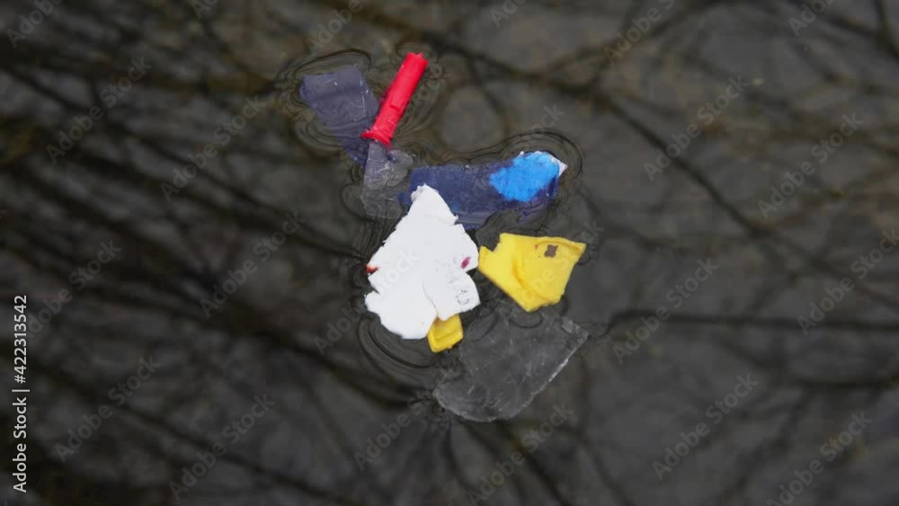 Residue of plastics in a river stream. Sea shore polluted with ...