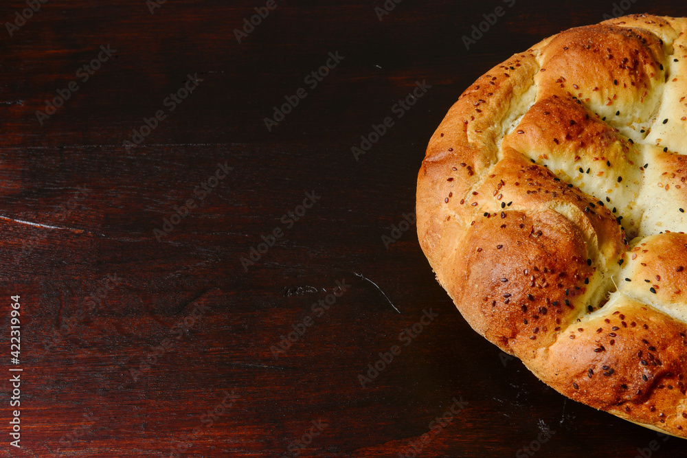 Turkish Ramadan Bread - Ramazan Pidesi on wooden table with yellow ...