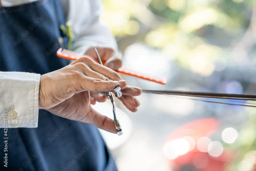 Close up shot at hand of Hair stylish while do hair cut and hair ...