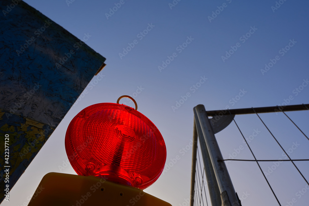 Warning light (Warnleuchte) of a construction site in the early morning ...
