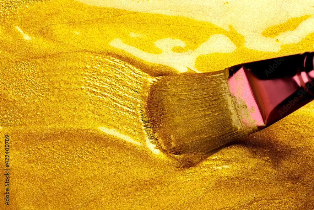Beautiful abstract golden liquid paint background with brush, beauty ...