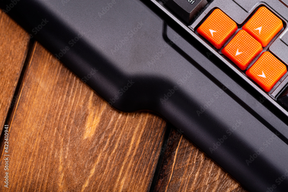 Orange arrow keys on a black keyboard, up, down, left, right buttons on ...