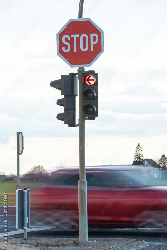 German stop sign and a traffic light showing red, arrow to the left ...