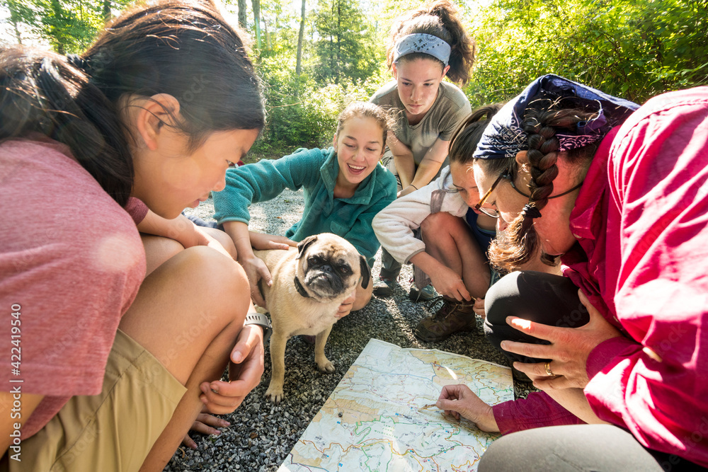 A group of girls reading a map while hiking the Appalachian Trail ...