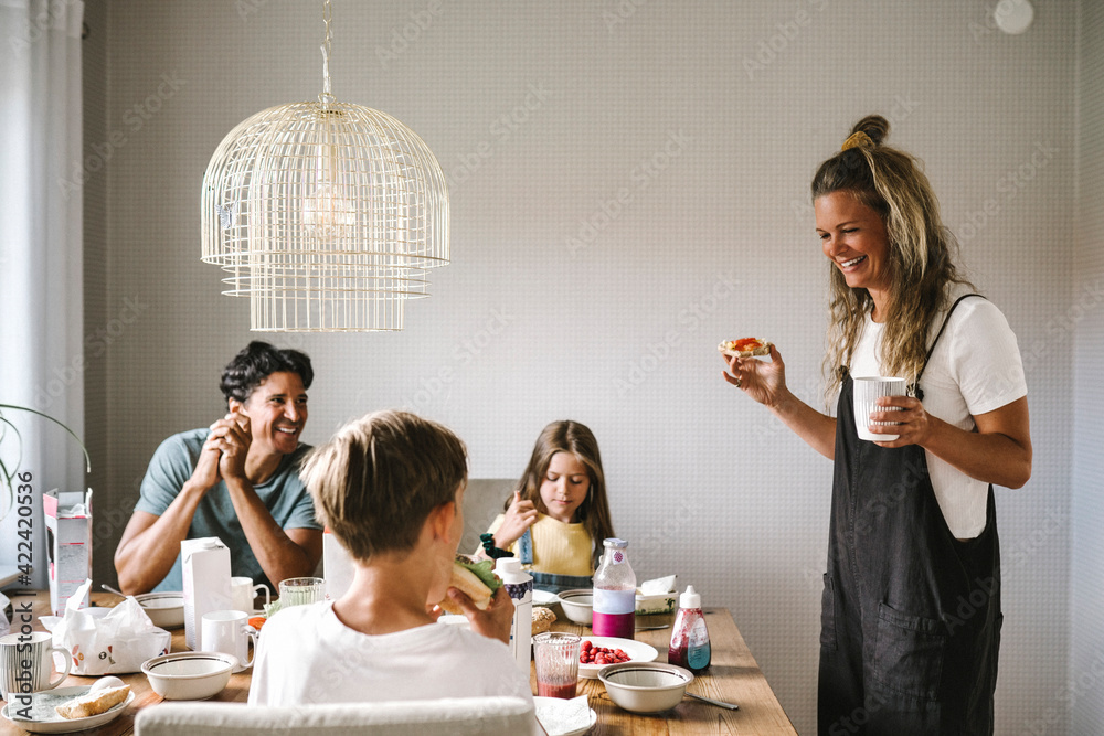 Smiling family having breakfast at dining table Stock Photo | Adobe Stock