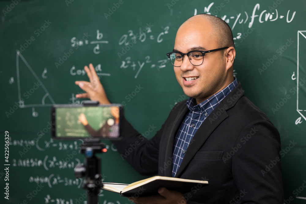 Indian young teacher man teaching online video conference live stream ...