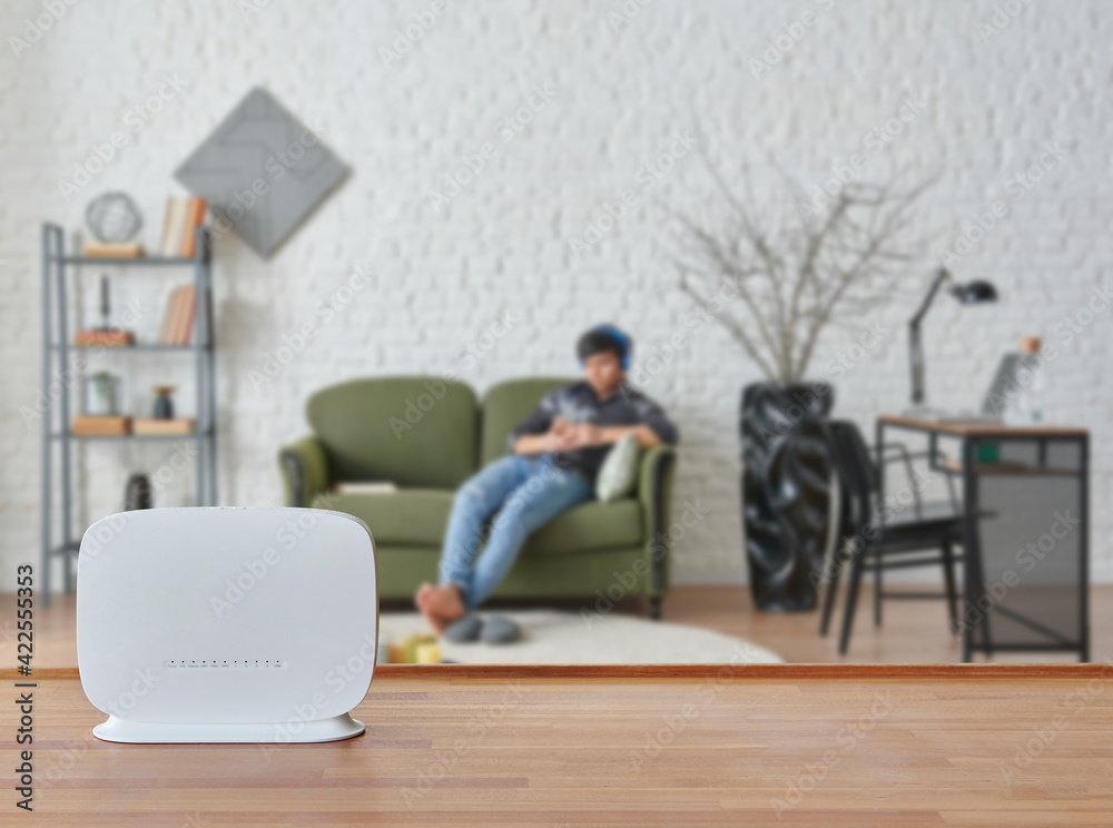 Modem and router box on the table and living room background blur ...