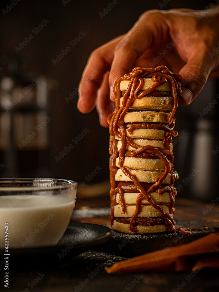 alfajores con arequipe y coco acompañados de leche Stock Photo | Adobe ...