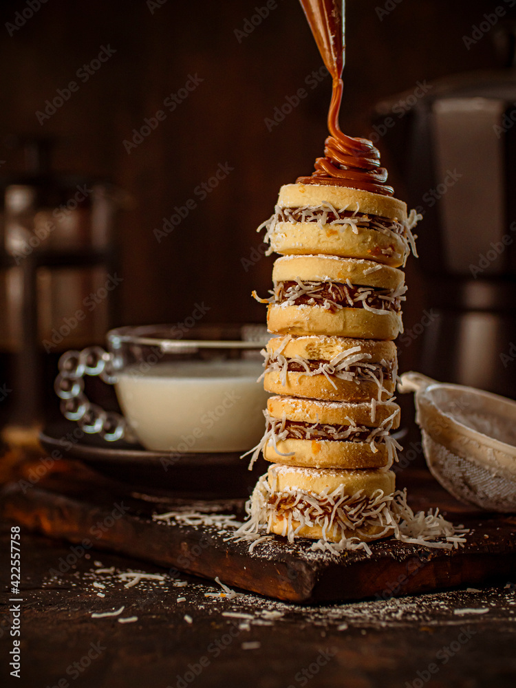 alfajores con arequipe y coco acompañados de leche Stock Photo | Adobe ...