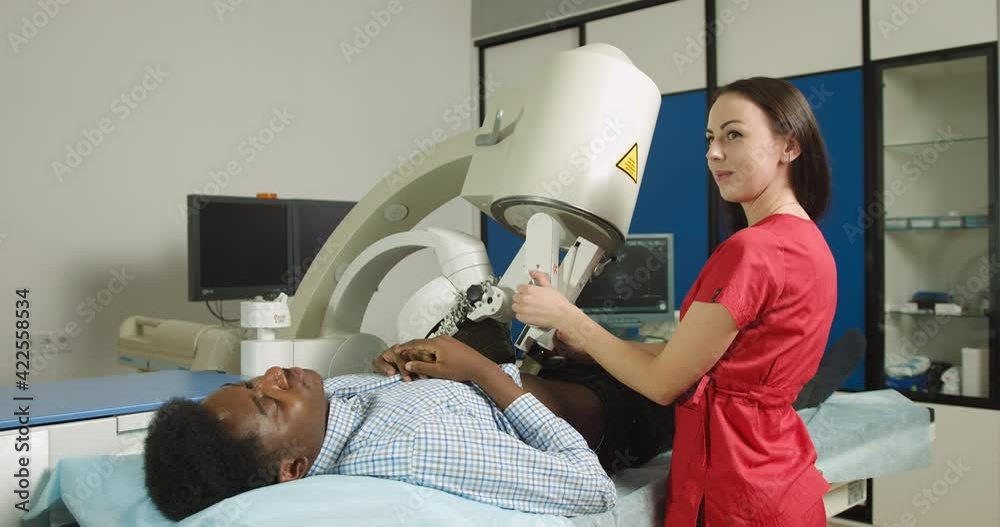 Lithotripsy for kidney and ureteral stones. Back view of woman doctor ...