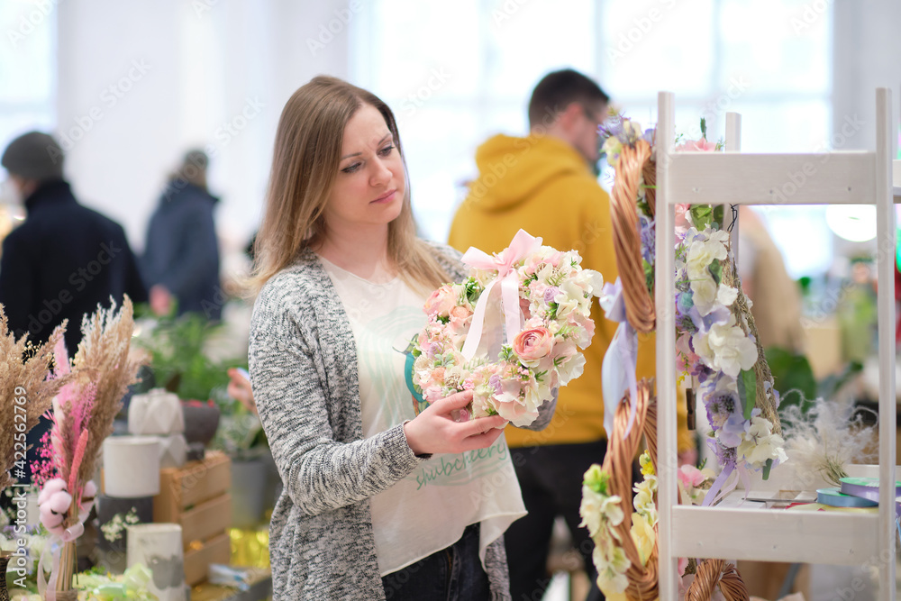 business owner selling behind counter with her bouquet of dried flowers ...