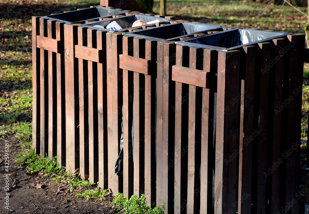 combined waste bin for sorting 4 types of waste. lined with brown wood ...