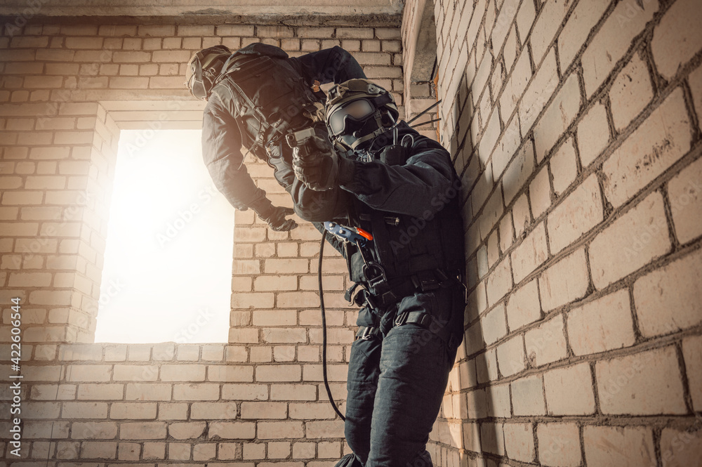 Group of special forces fighters storm the building through the window ...