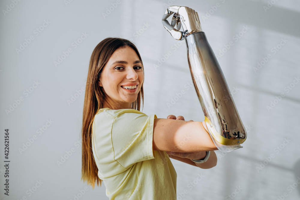 Portrait of a strong and independent woman with a bionic prosthetic arm ...