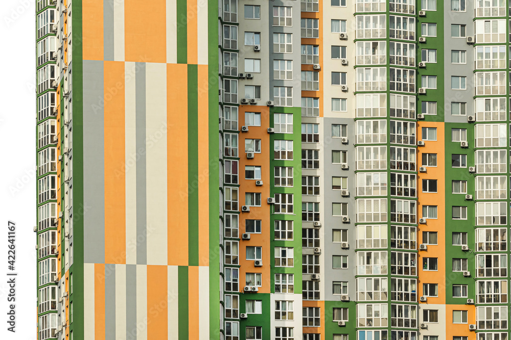 The facade of a multi-storey building with windows and balconies as an ...