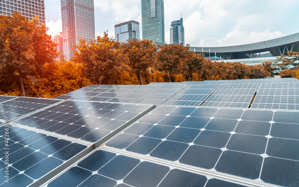 Ecological energy renewable solar panel plant with urban landscape ...
