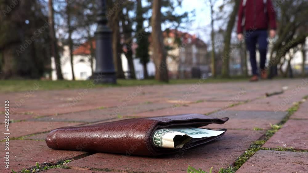Caucasian Male Picking Up A Lost Brown Leather Wallet Laying on the ...