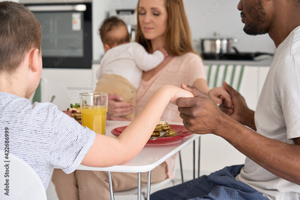 Foto de Close up view of multiracial family with children holding hands ...