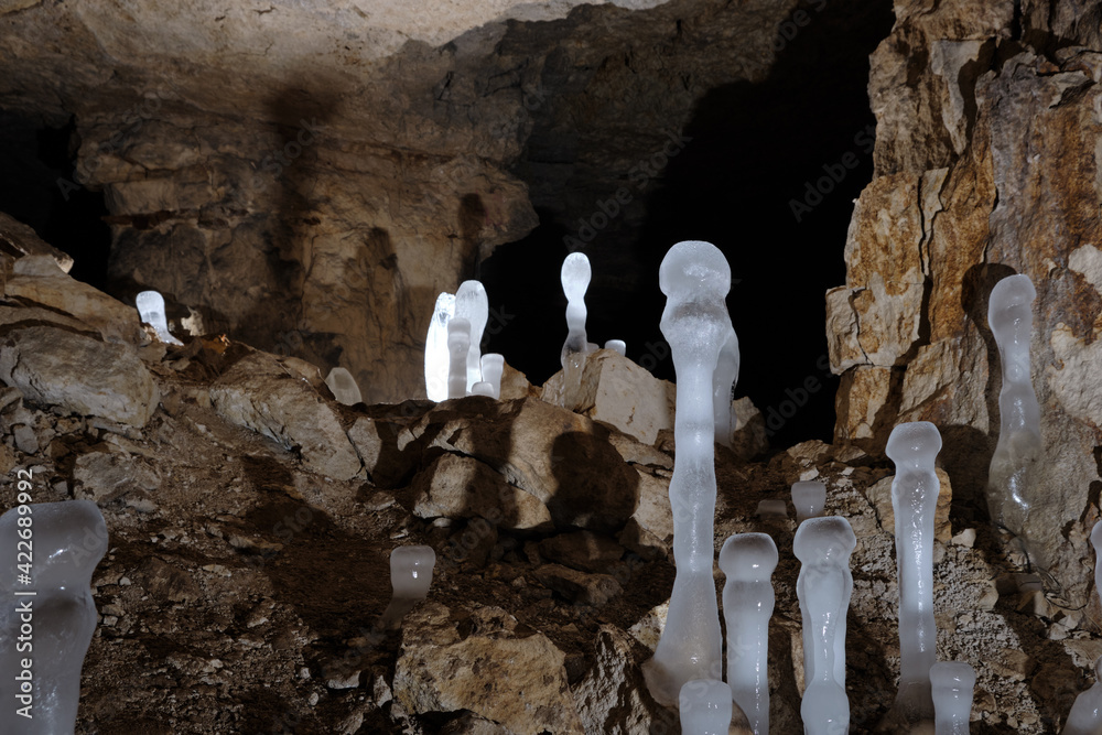 Ice stalactites in an abandoned quarry mine. Travel under the ...