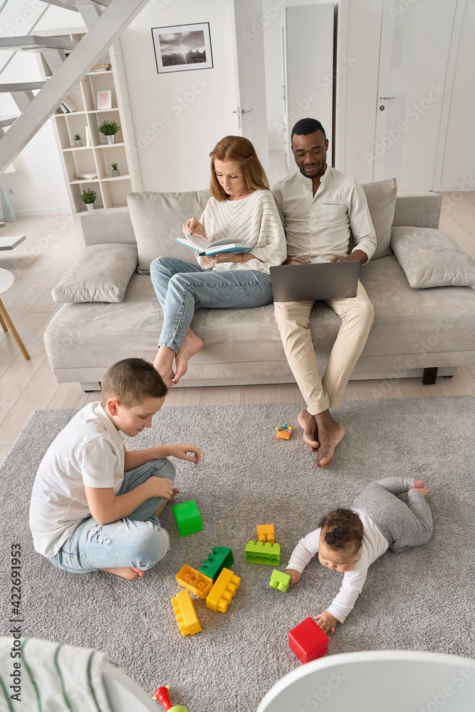 Multiracial family doing activities together at home. Mixed race ...
