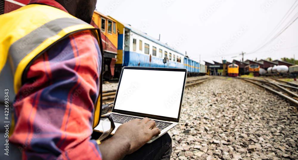 Engineers working on railway train statation and holding white screen ...