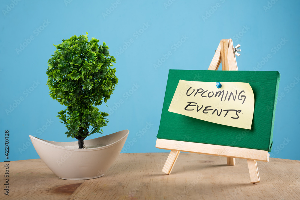 upcoming events written on a sticky note on a mini green notice board ...