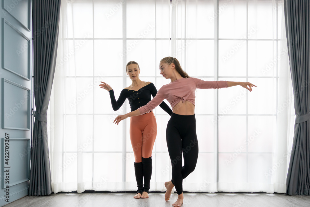 Female ballet teachers training ballerina to have right postures in the ...