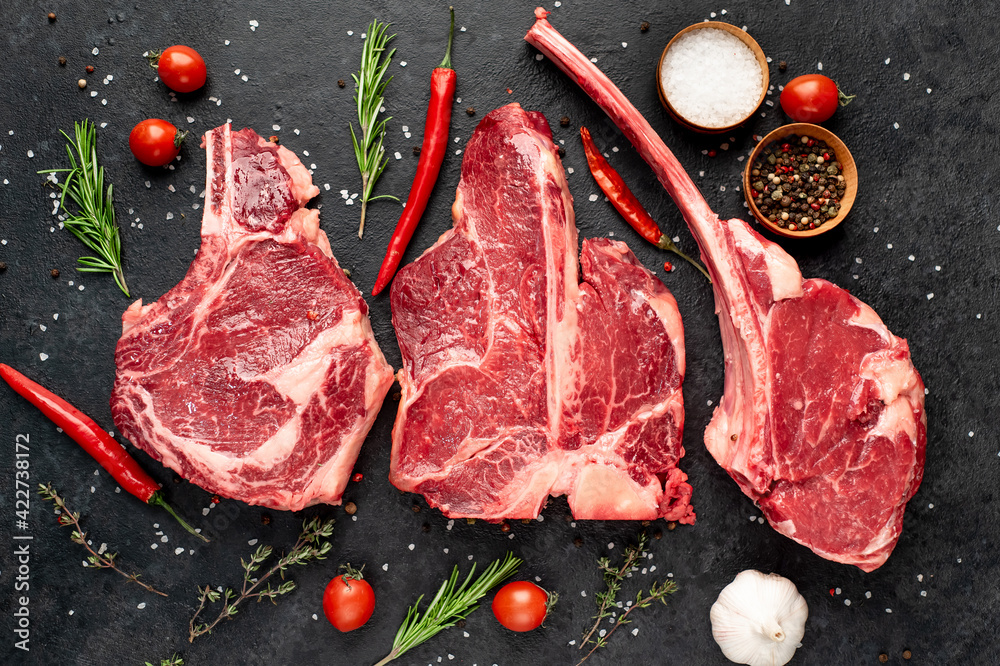 Three raw beef steaks for grilling - rib-eye steak, T-Bone steak ...