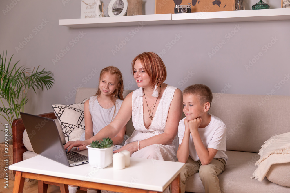mother teaches children at home. homeschooling. the teacher is engaged ...